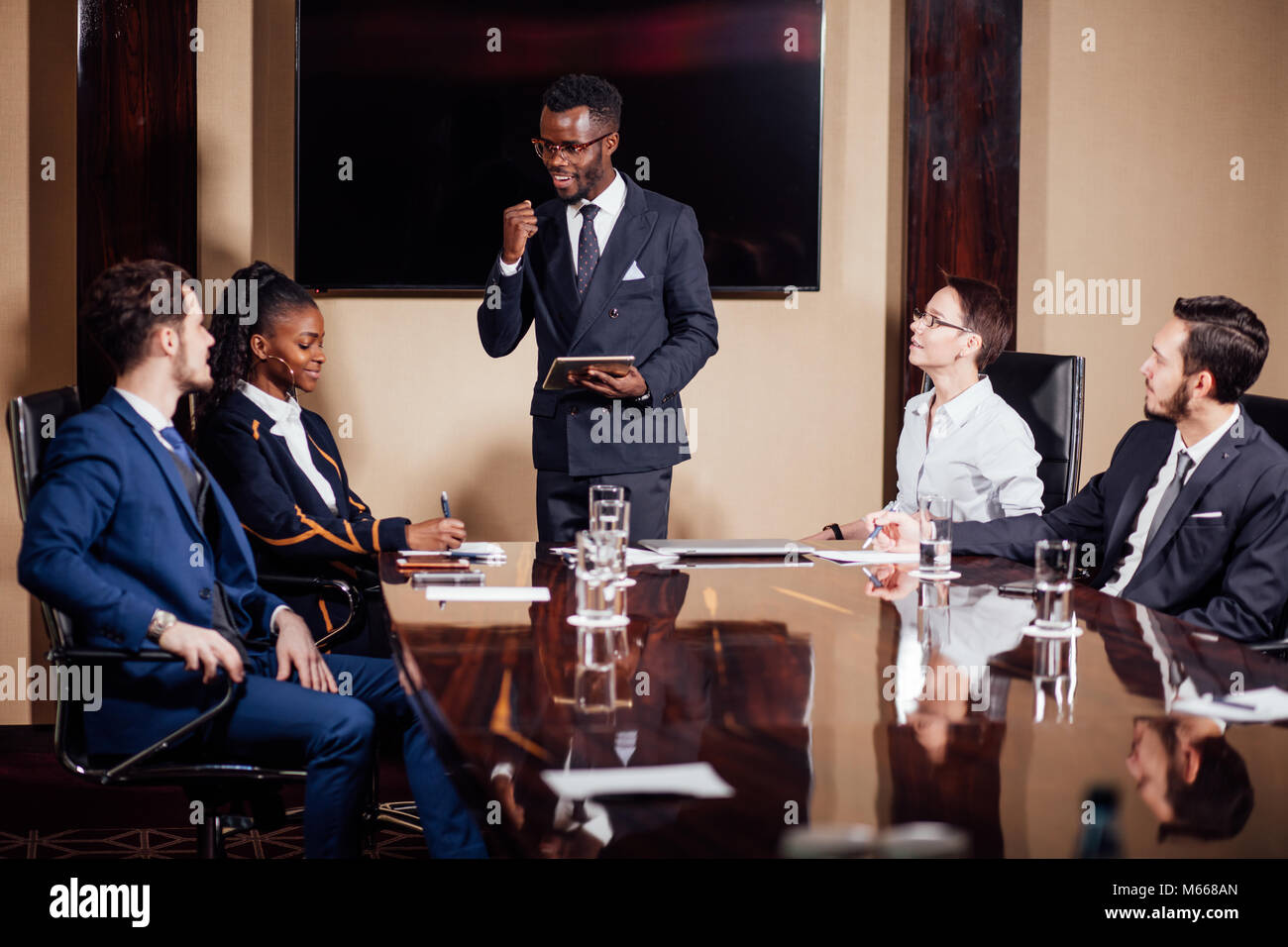 African American business man giving presentation to associates Stock ...