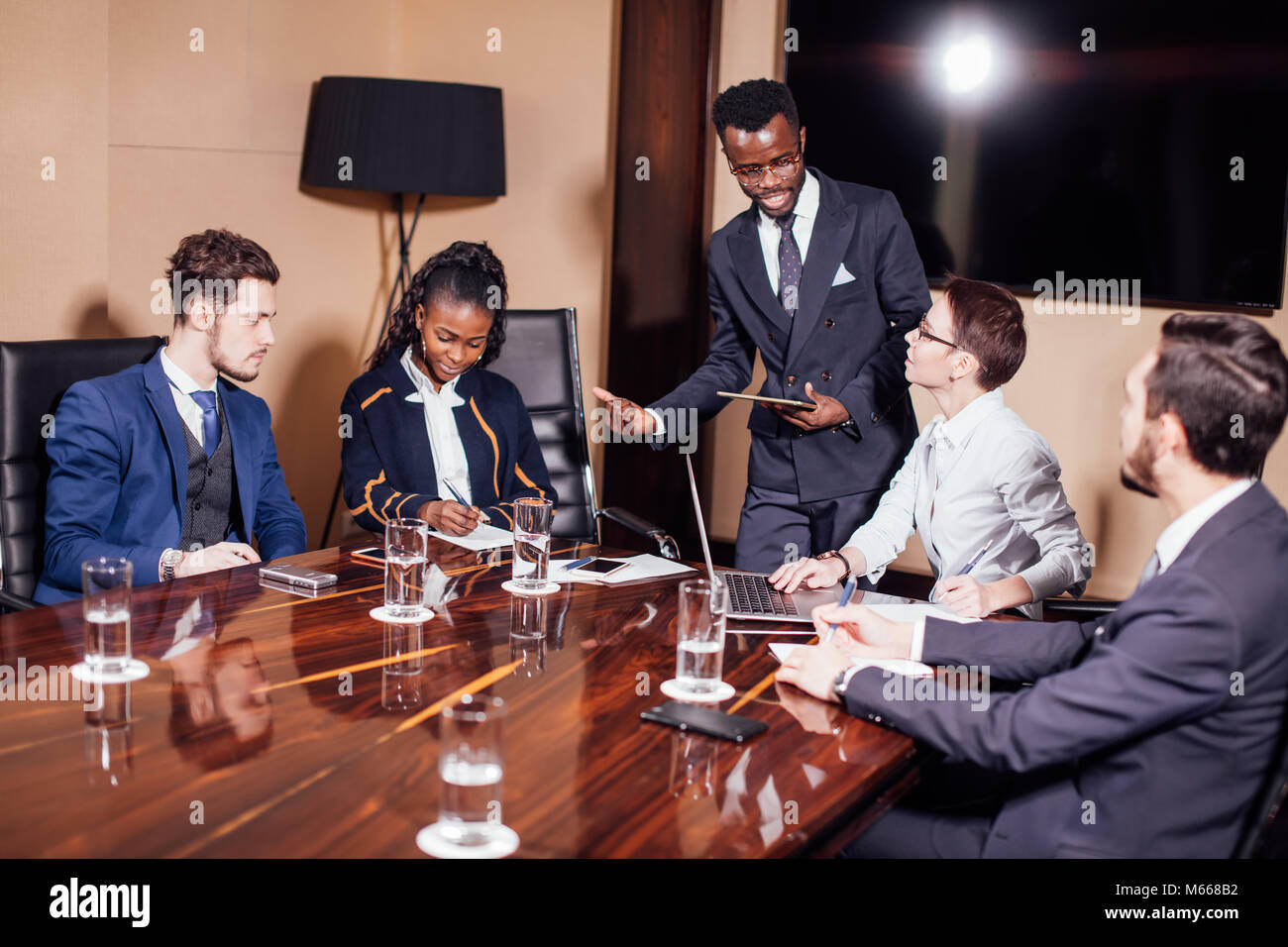 African American business man giving presentation to associates Stock ...