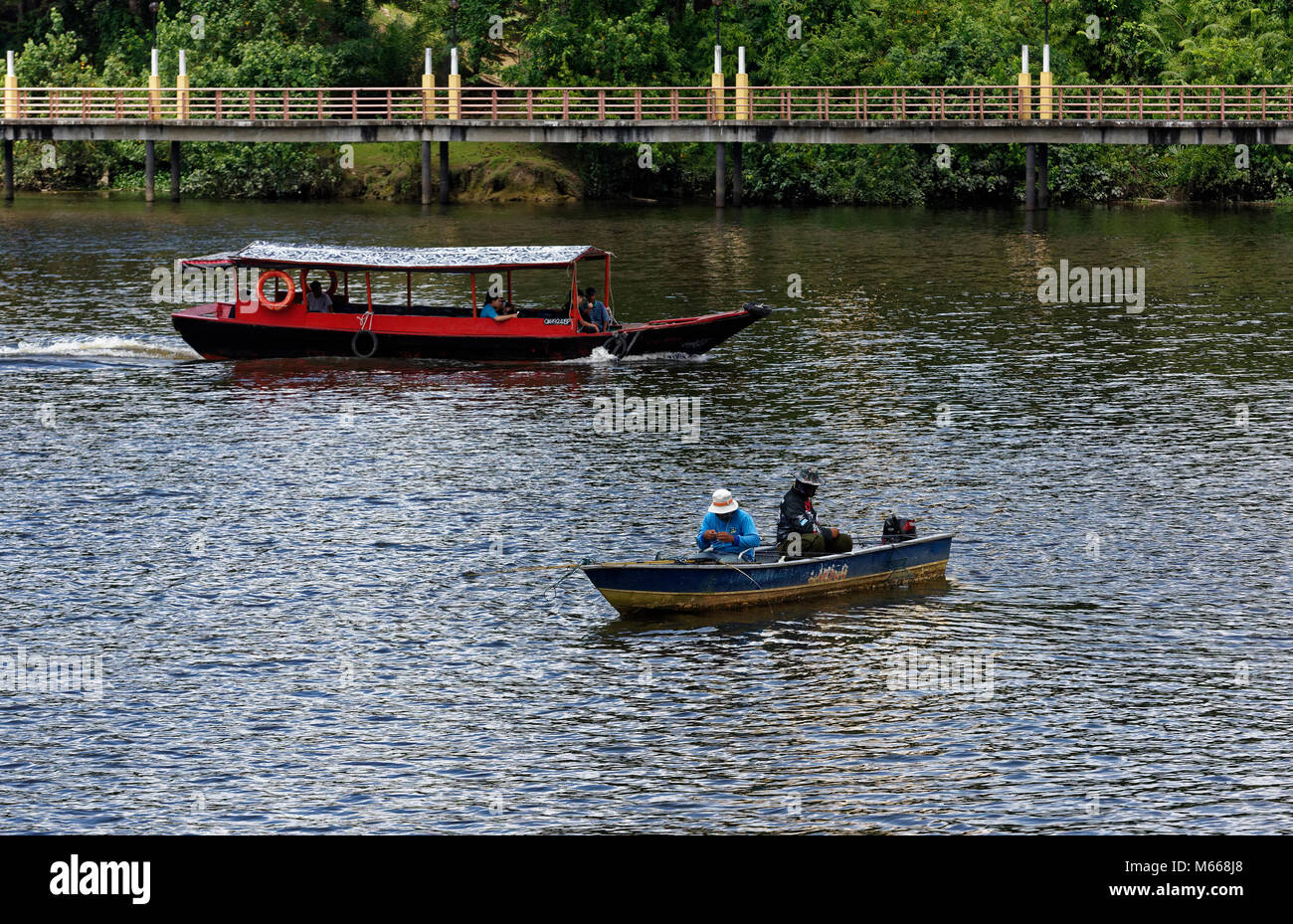 Sampan passing fishermen on the Sarawak River, Kuching Stock Photo - Alamy