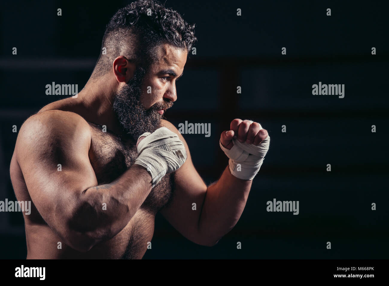 man boxing workout on ring. Caucasian male boxer in black gloves Stock ...