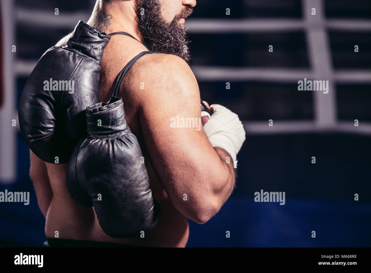 guy back towards camera, pair of boxing gloves over his shoulder Stock ...