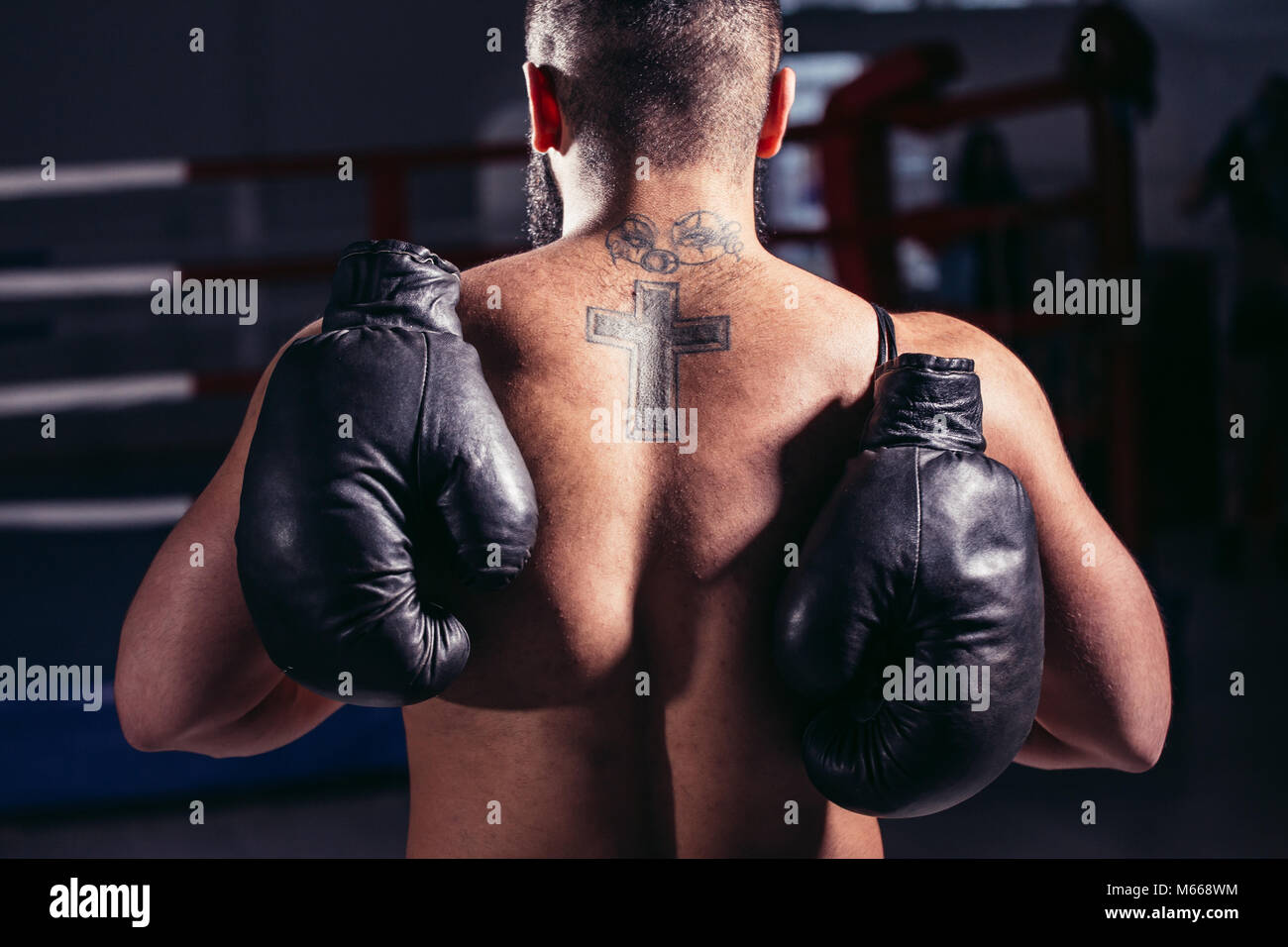 guy back towards camera, pair of boxing gloves over his shoulder Stock ...