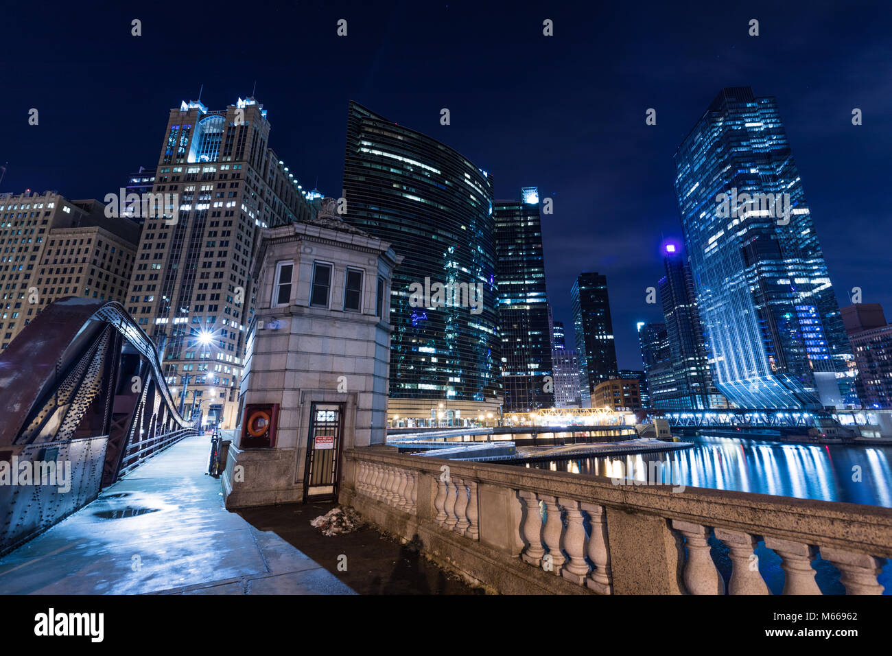Chicago downtown illuminated view by the river at night from the bridge ...