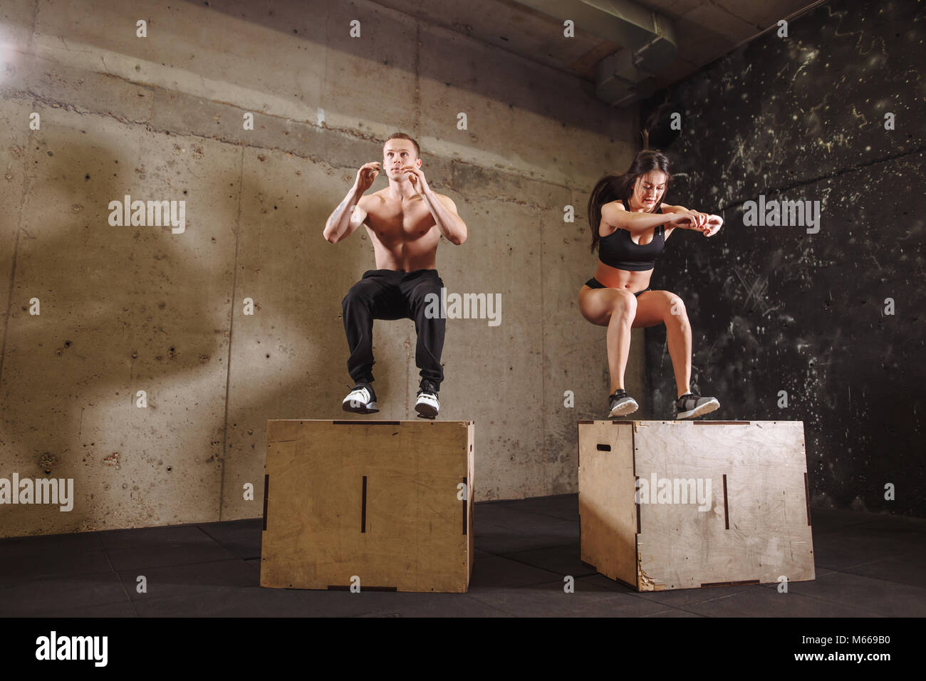 man and woman jumping on fit box Stock Photo - Alamy