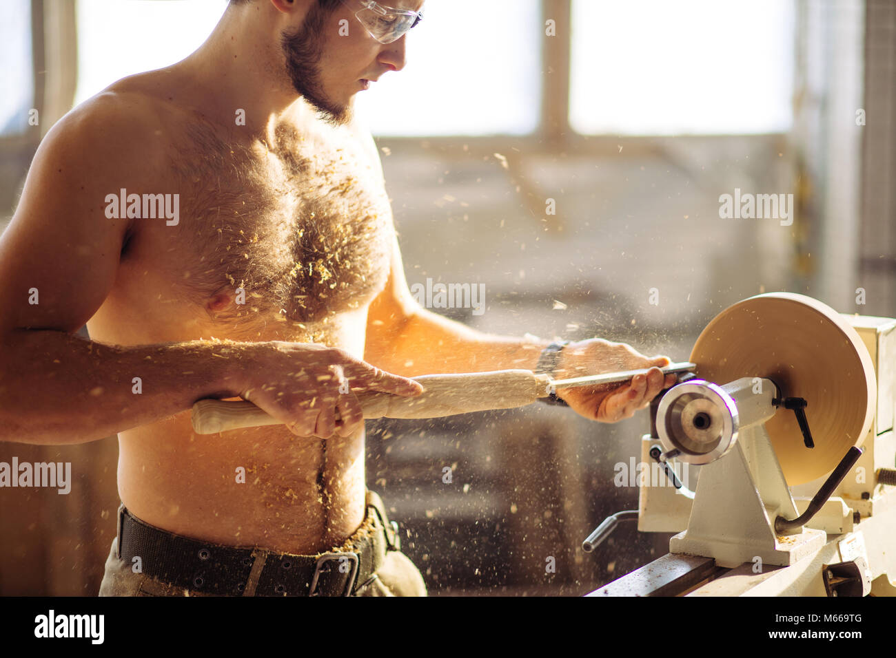 Wood lathe. Carpenter lathing wood Stock Photo - Alamy