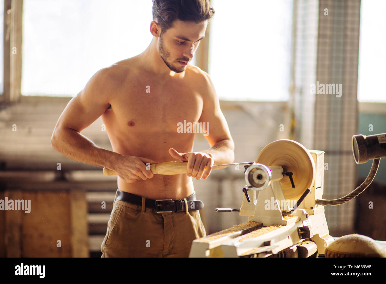 Wood lathe. Carpenter lathing wood Stock Photo - Alamy