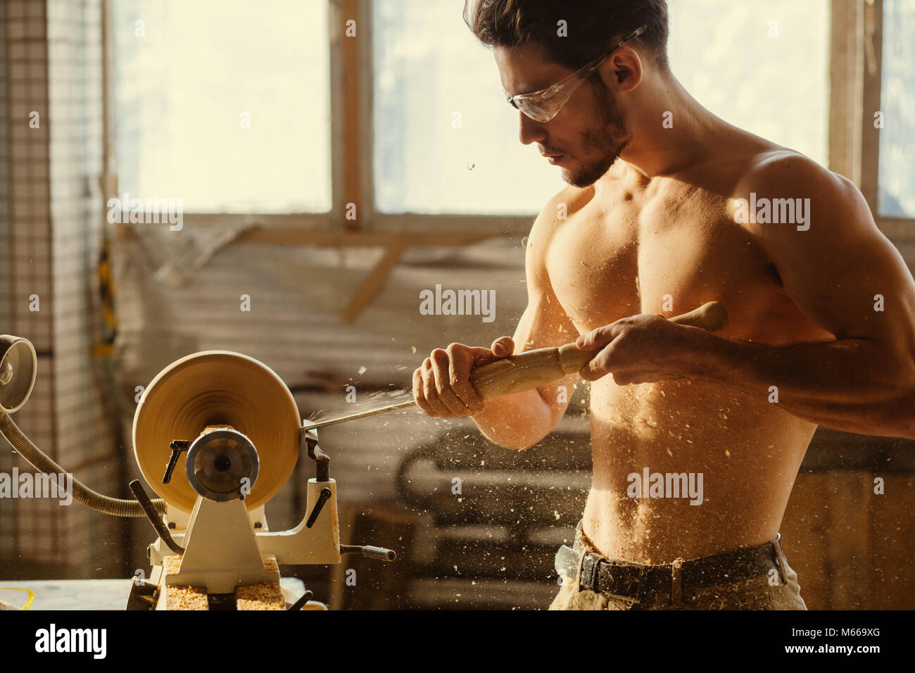 Wood lathe. Carpenter lathing wood Stock Photo - Alamy