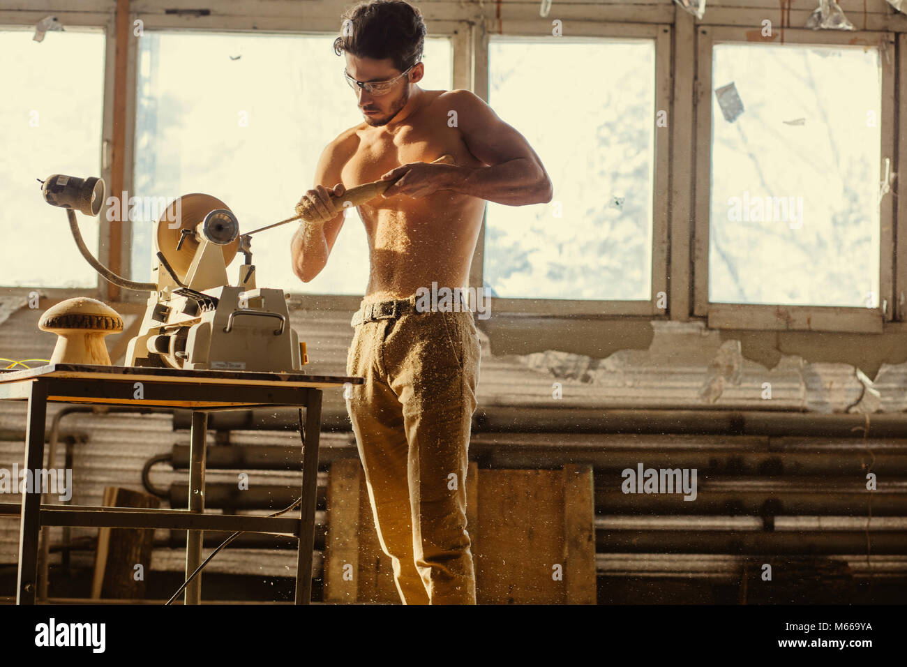 Wood lathe. Carpenter lathing wood Stock Photo - Alamy