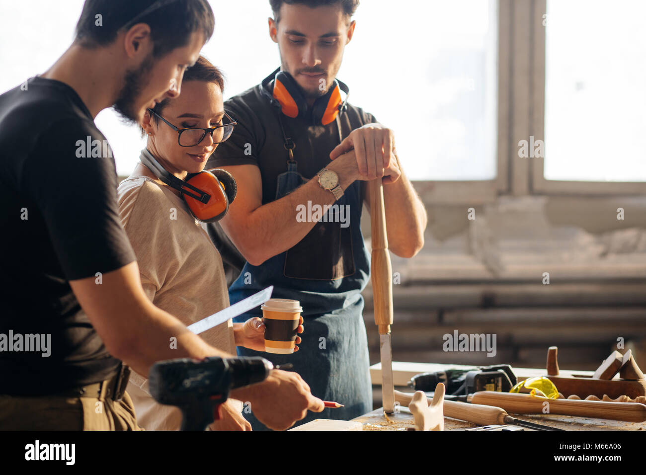 Carpenter Training Female Apprentice To Use Plane Stock Photo - Alamy