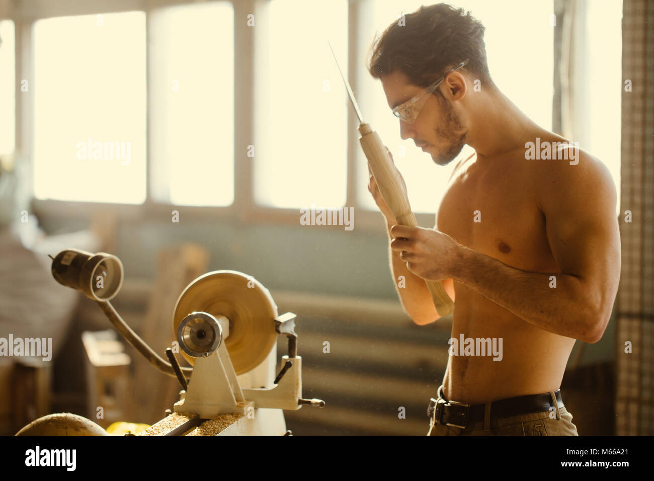 Wood lathe. Carpenter lathing wood Stock Photo - Alamy