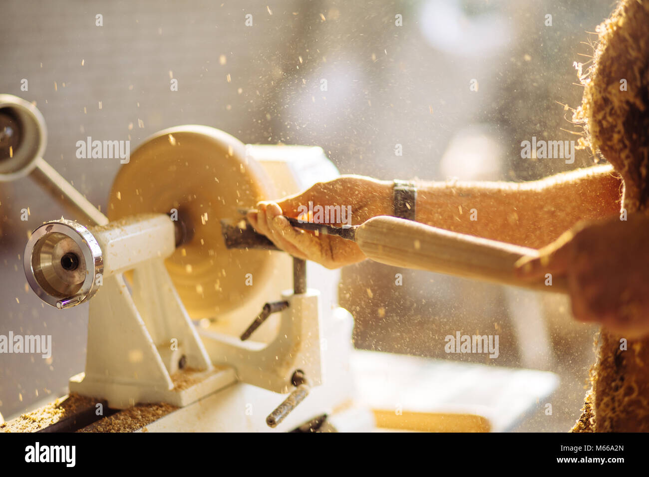 Wood lathe. Carpenter lathing wood Stock Photo - Alamy