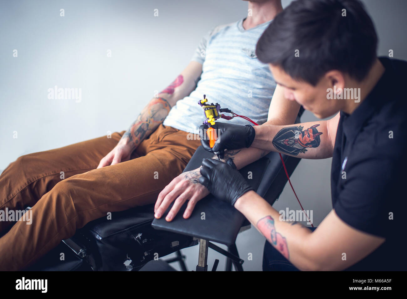 Master makes tattoo in tattoo studio Stock Photo - Alamy Master makes tattoo in tattoo studio Stock Photo - Alamy