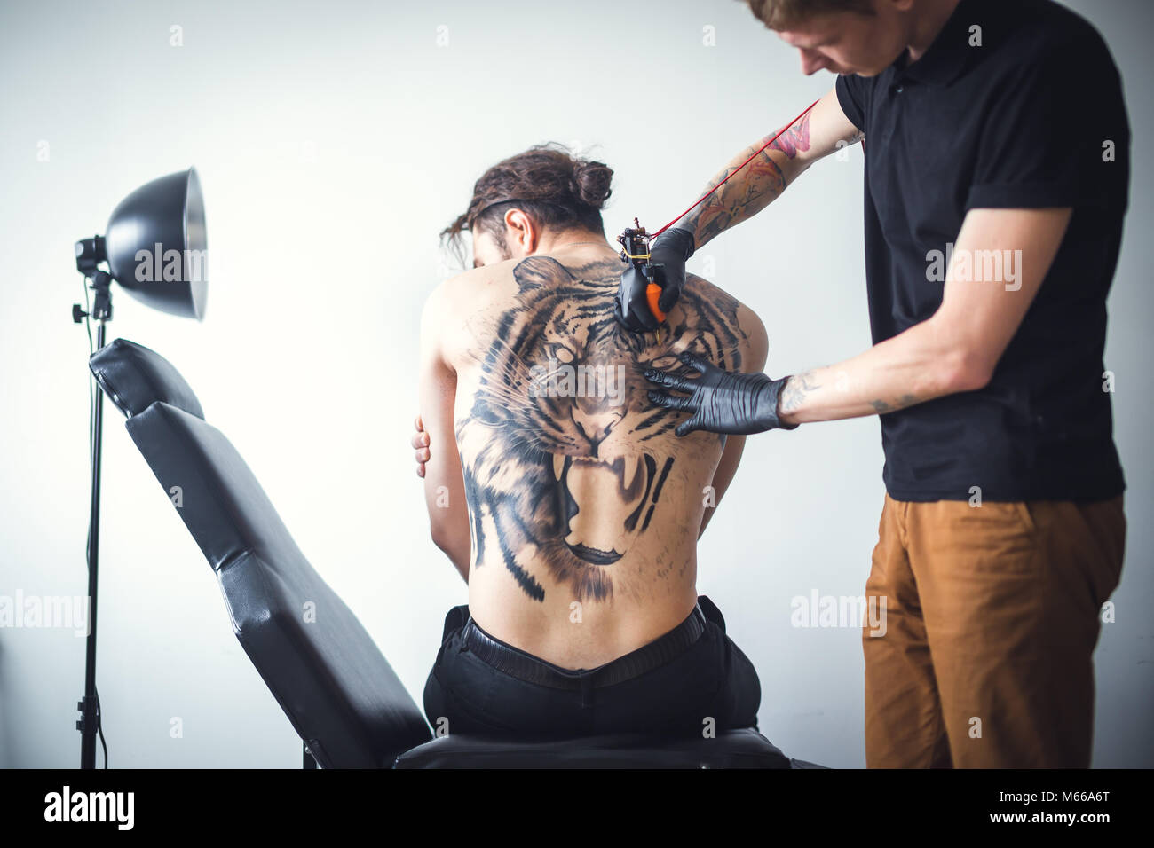 Tattoo tiger on the back Stock Photo - Alamy