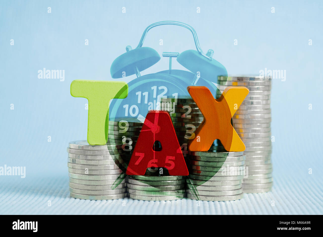 TAX concept. Word TAX alphabet made from wood with stack of coin ...