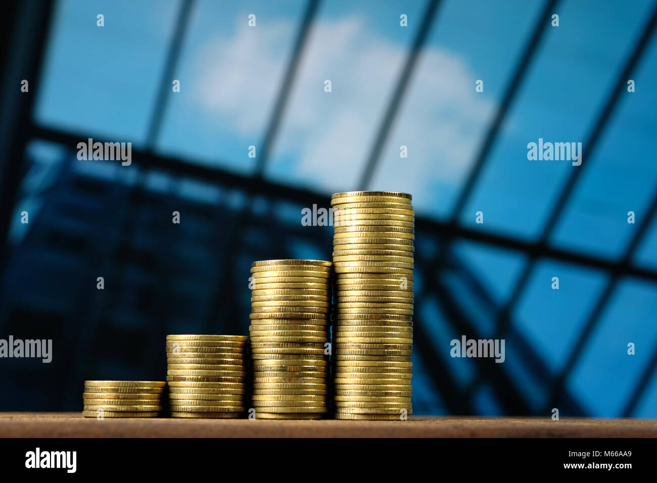 Step of coin stack on top wooden working table with city and office ...