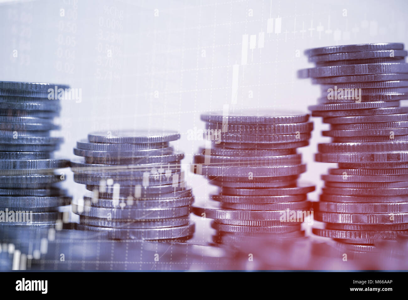 Double exposure of coin stack with stock market screen chart board and ...