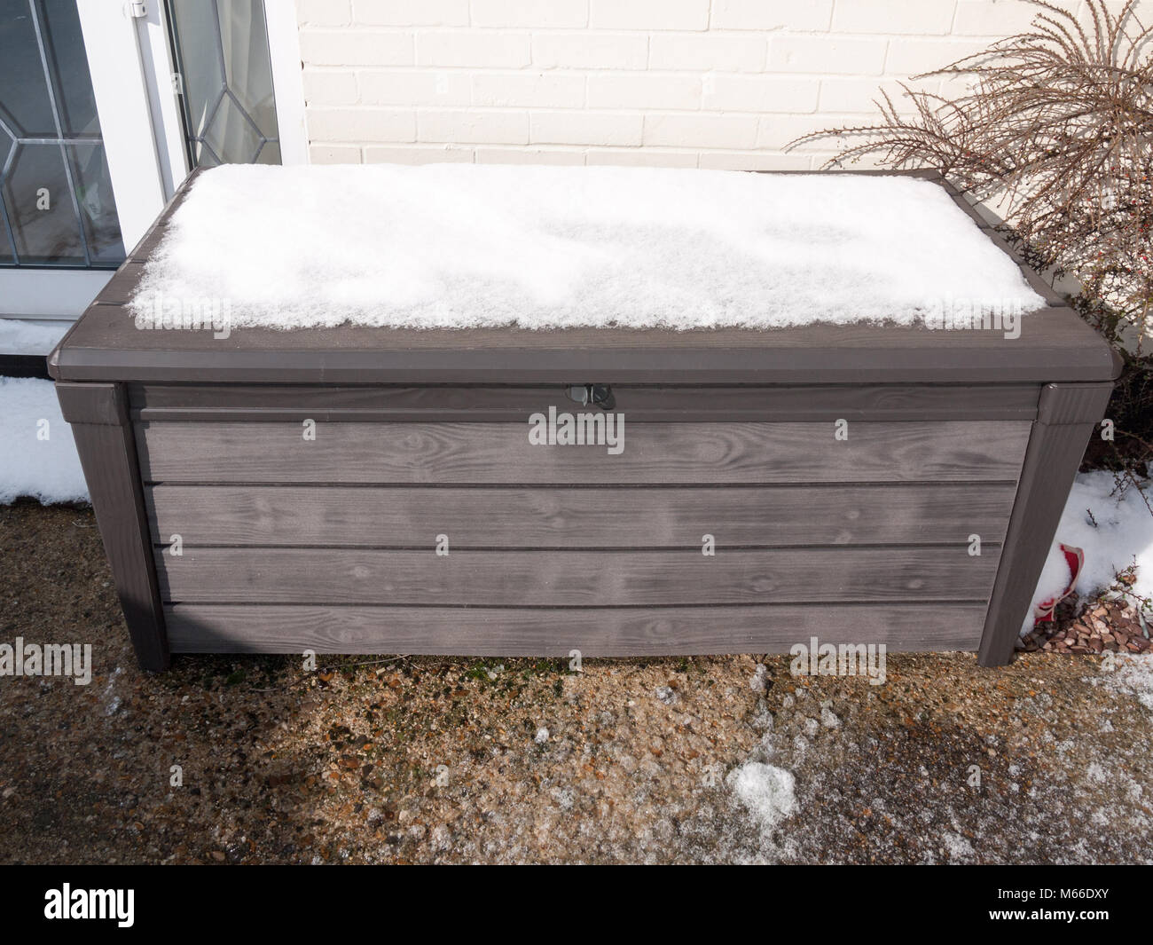 snow on top of plastic container outside in garden closed locked; essex ...