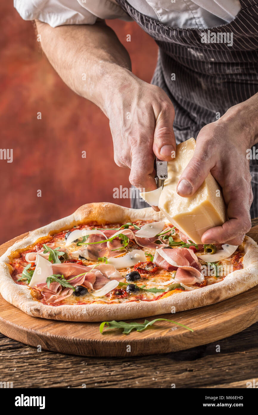 Pizza and Chef. Chef in the restaurant prepares a pizza and decorates ...
