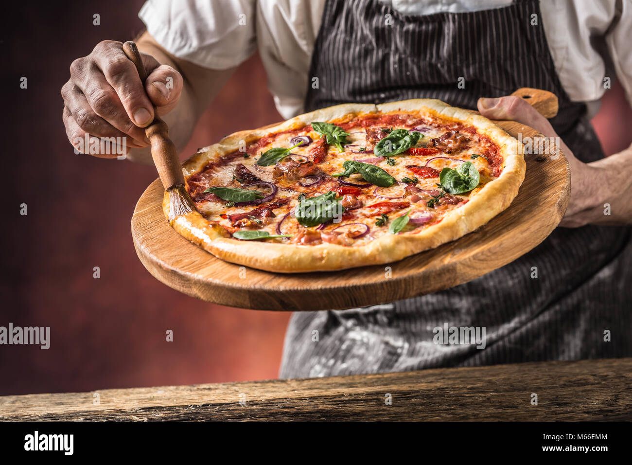 Pizza and Chef. Chef in the restaurant prepares a pizza and decorates ...