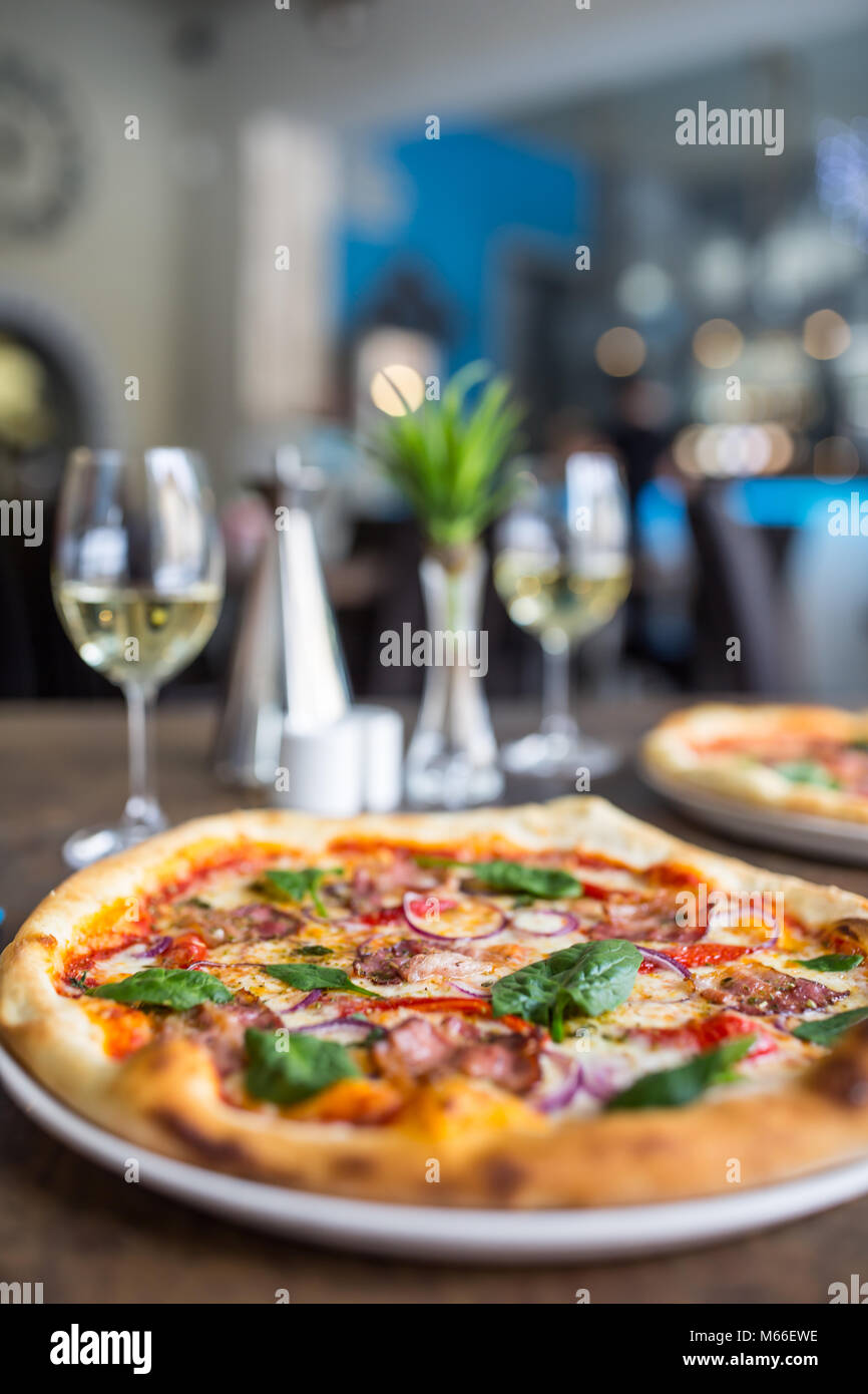 The served dinner table with pizza in pizzeria or restaurant Stock ...