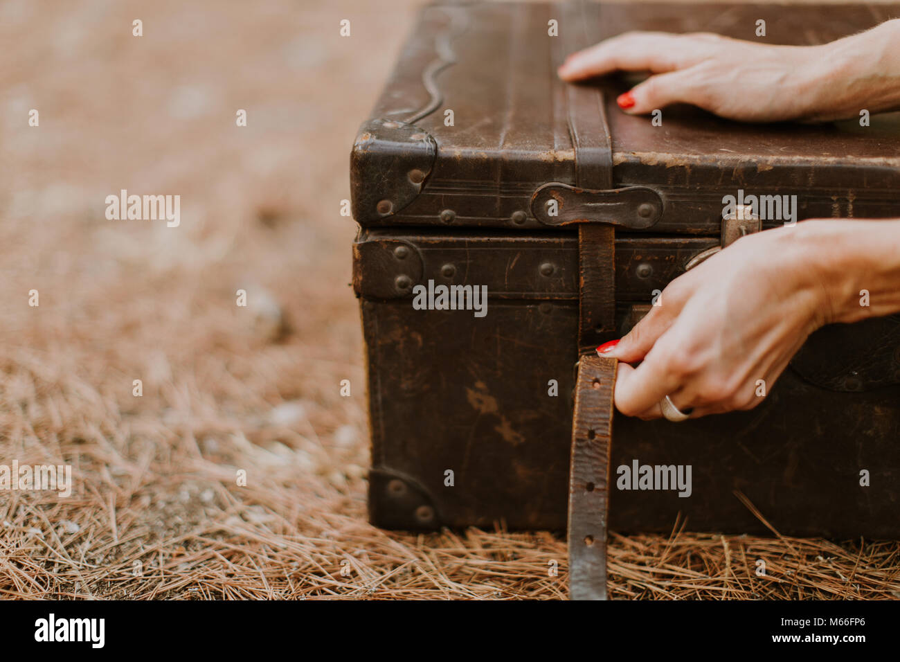 Woman closing a vintage suitcase Stock Photo - Alamy