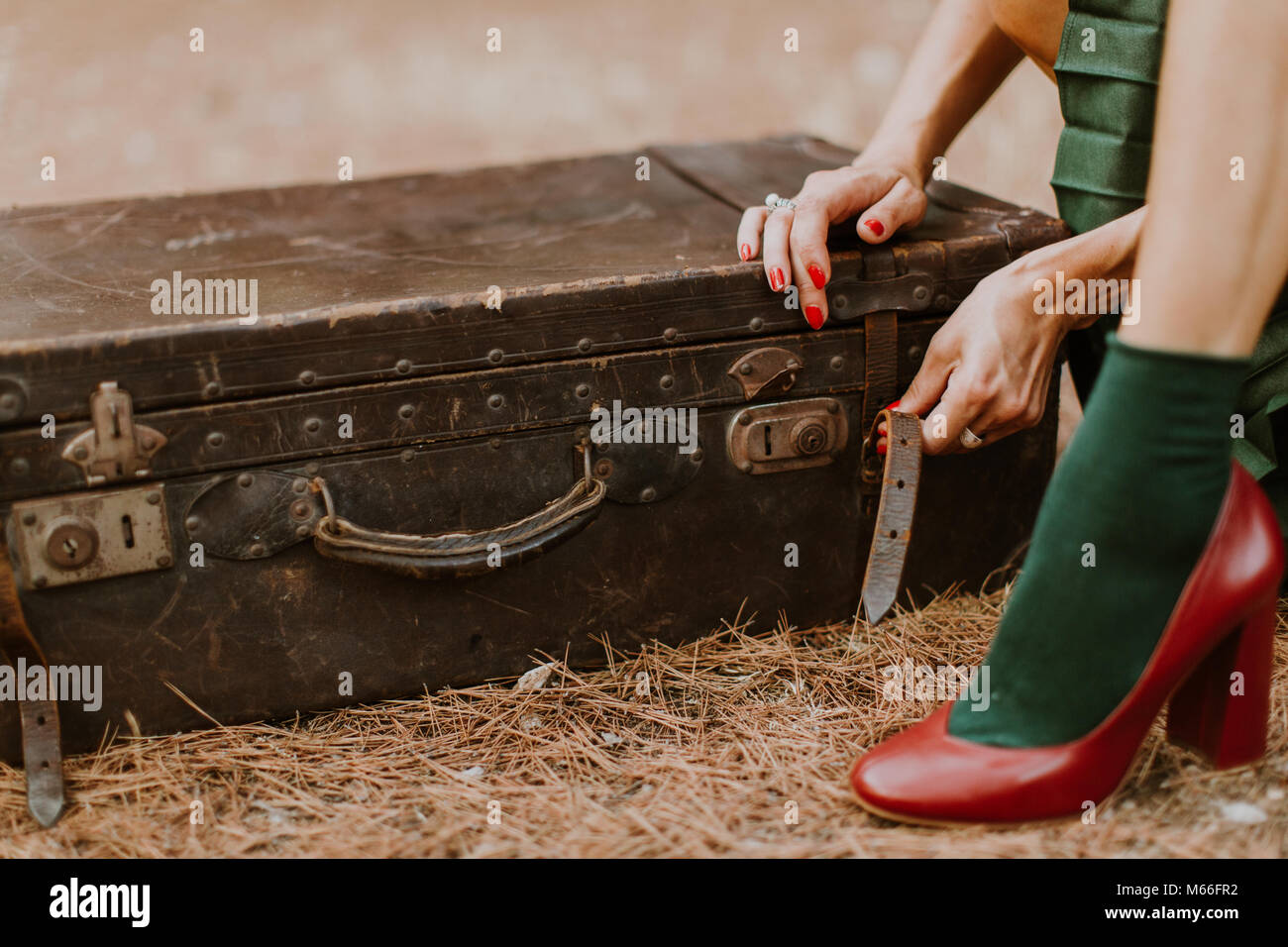 Woman closing a vintage suitcase Stock Photo - Alamy