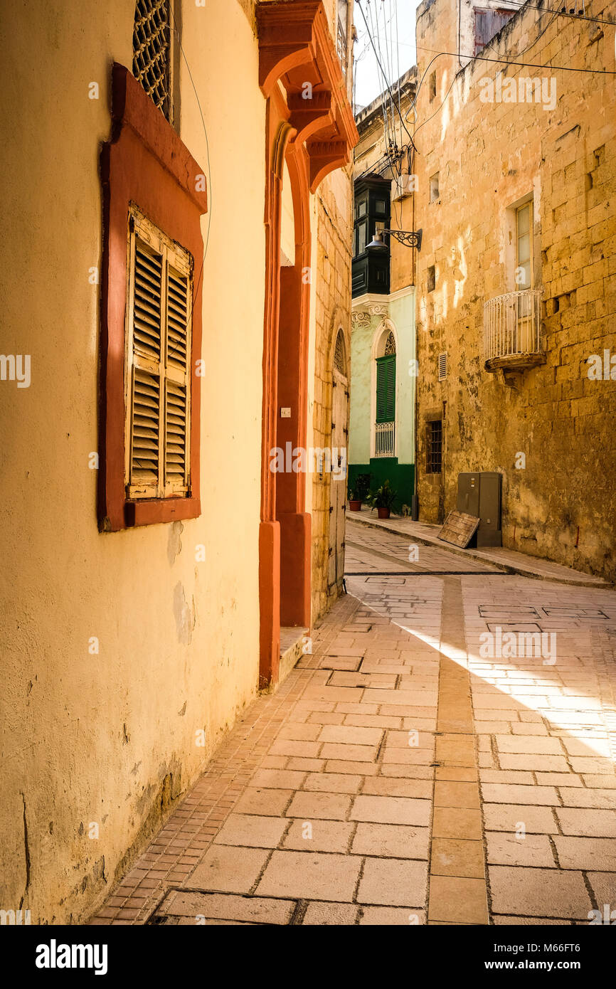Valletta iconic narrow city streets at sunset Stock Photo - Alamy