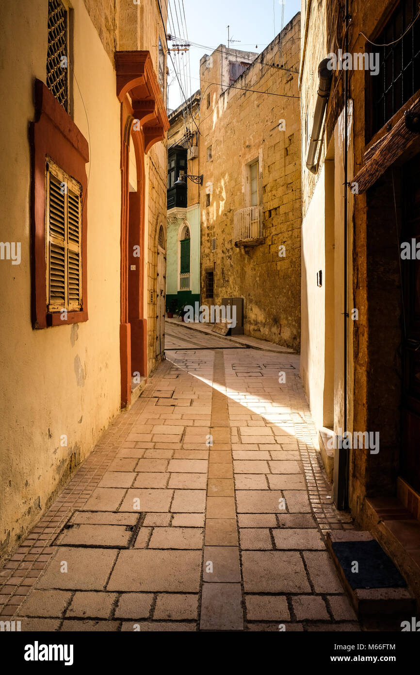 Valletta iconic narrow city streets at sunset Stock Photo - Alamy