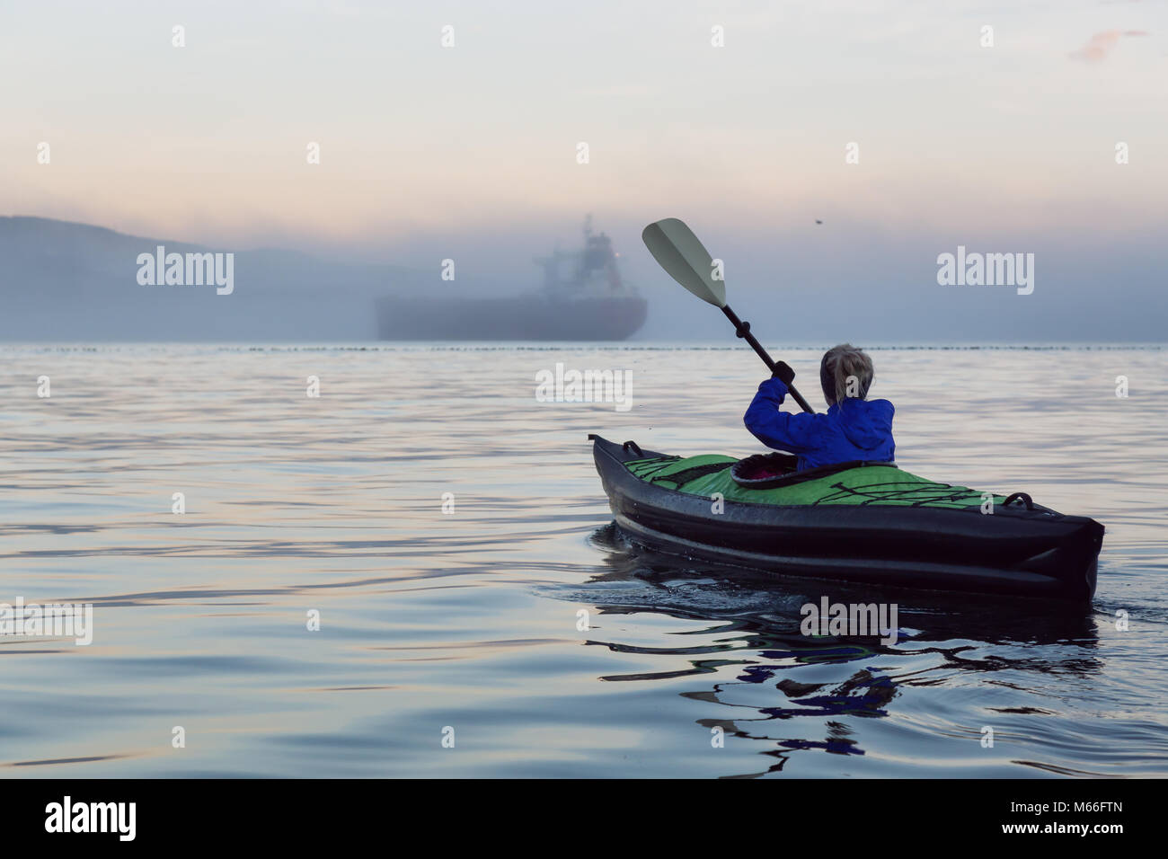 Adventure girl is kayaking on an inflatable kayak in Horseshoe Bay with ...