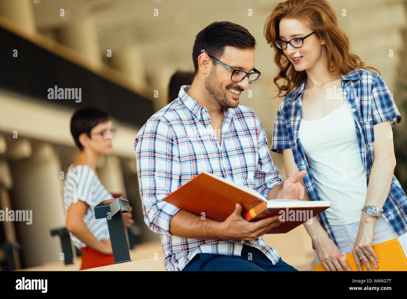 Young students studying in library Stock Photo - Alamy