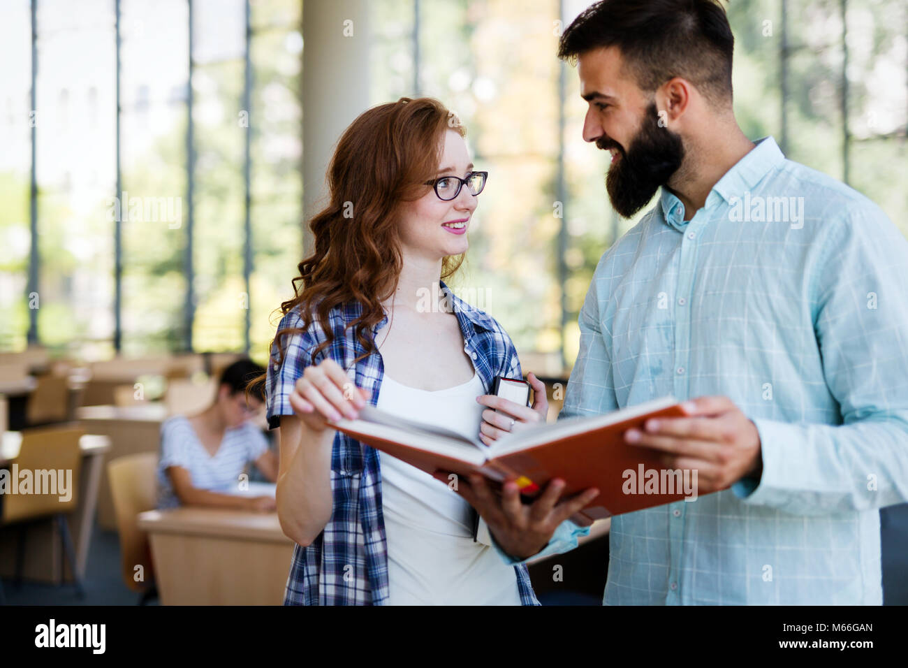 Group of college students at the library Stock Photo - Alamy