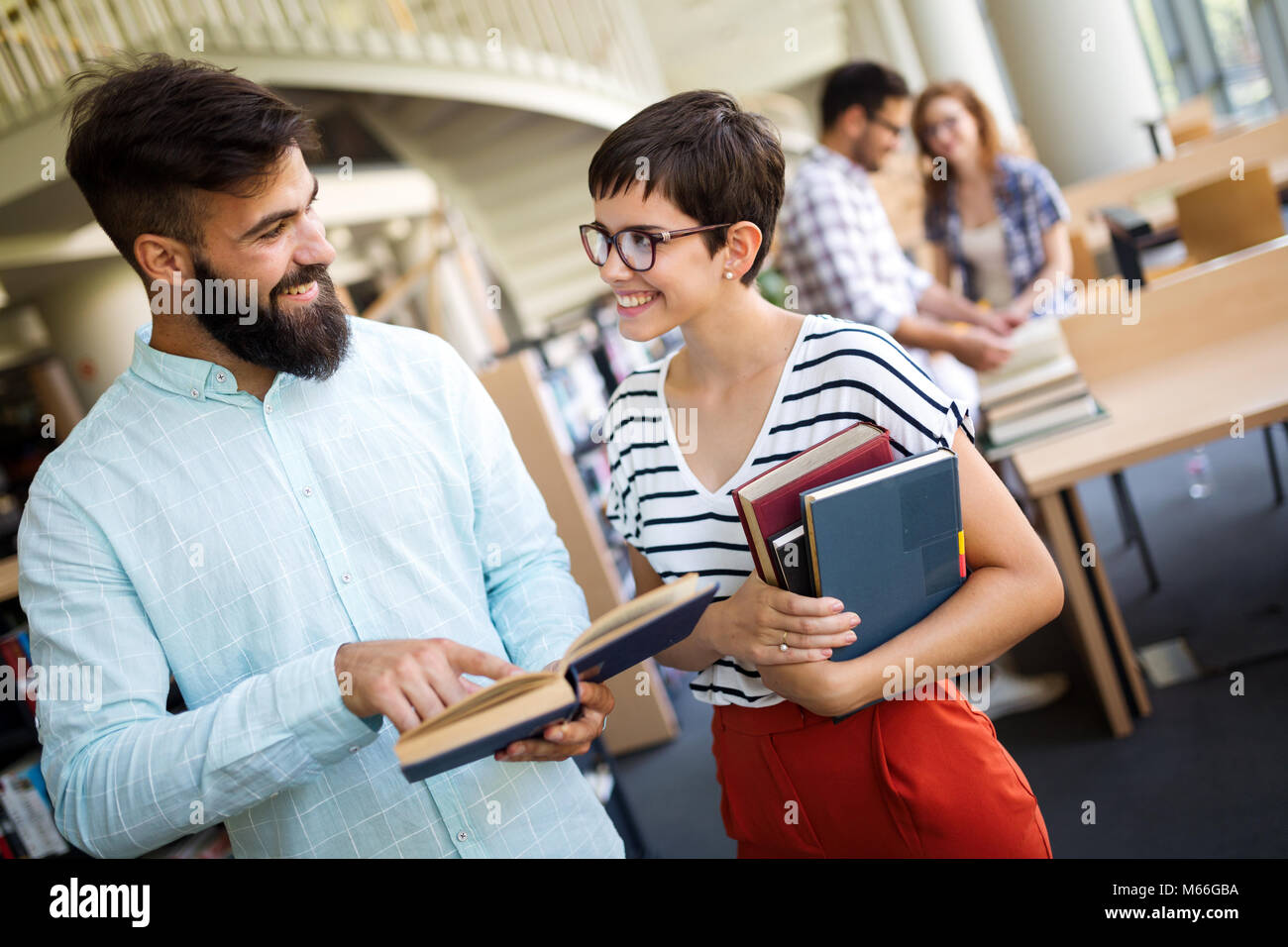 Group of college students studying at library Stock Photo - Alamy