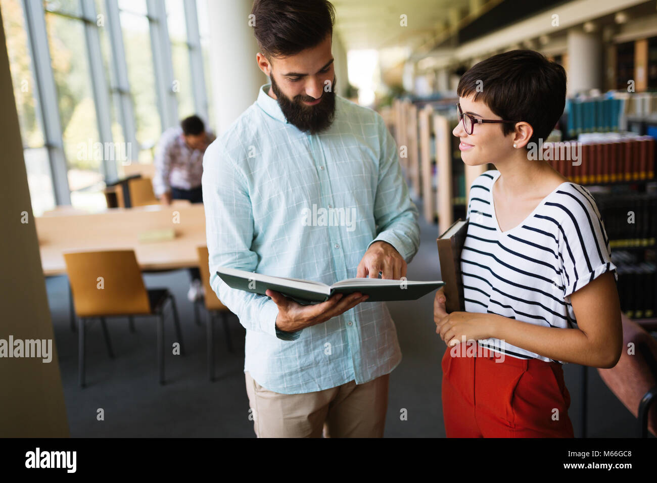 Young students studying in library Stock Photo - Alamy