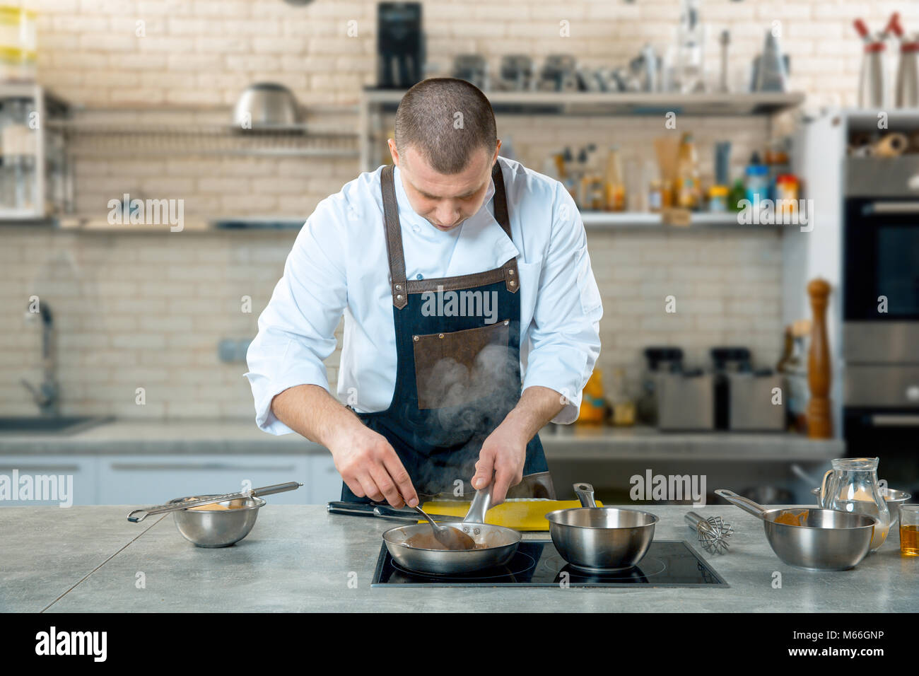 Chef is stirring vegetables in wok on kithen interior. cooking process ...