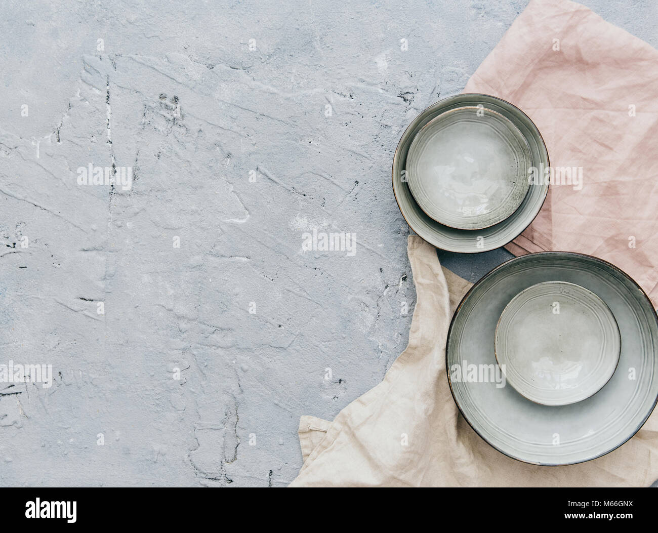 Ceramic bowls on a textured background Stock Photo - Alamy