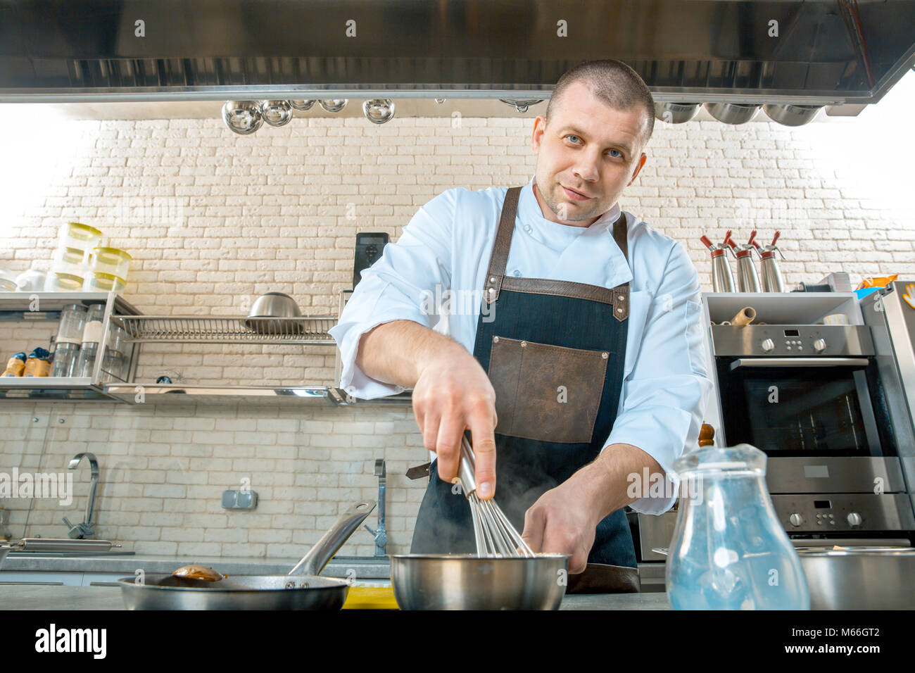 Focused chef preparing a polenta in the restaurant kitchen. cooking ...