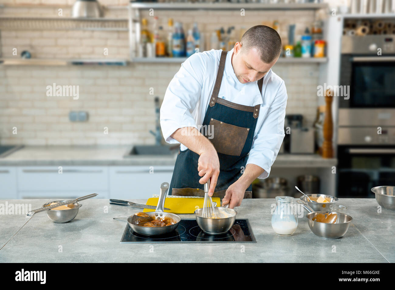 Focused chef preparing a polenta in the restaurant kitchen. cooking ...