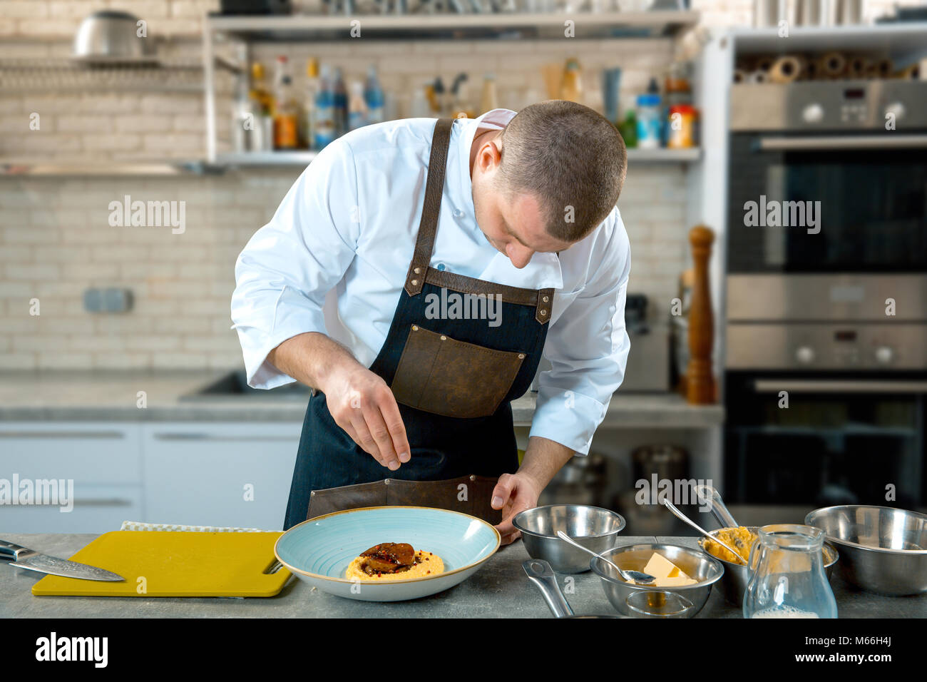 food cooking, profession and people concept - male chef cook serving ...