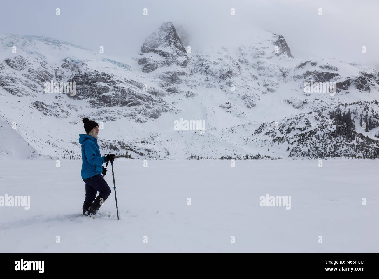 Adventure woman is hiking in the beautiful Canadian Snow Covered ...