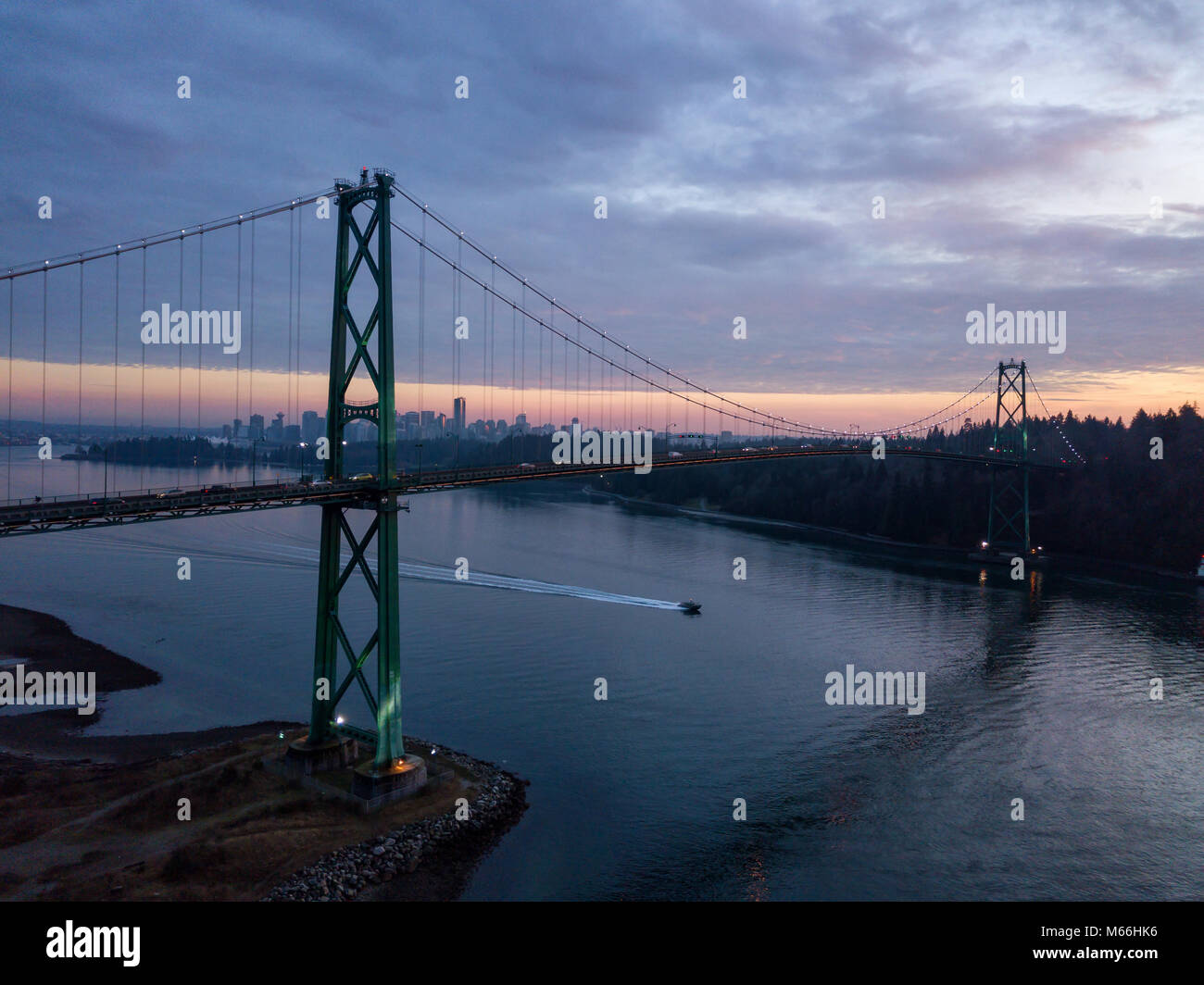 Aerial view of a famous landmark, Lions Gate Bridge, with downtown city ...