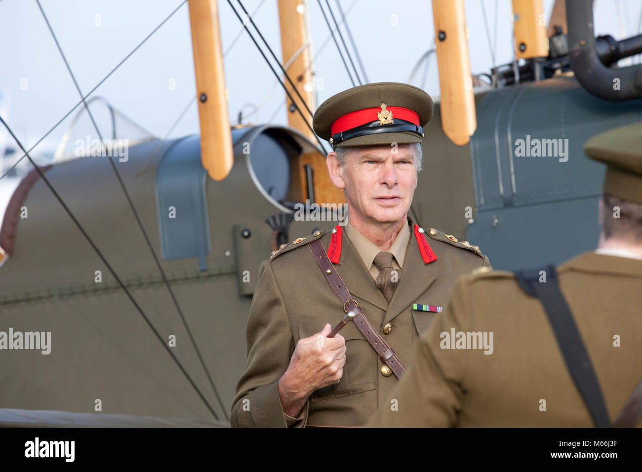Goodwood revival, man in vintage uniform standing with vintage plane in ...