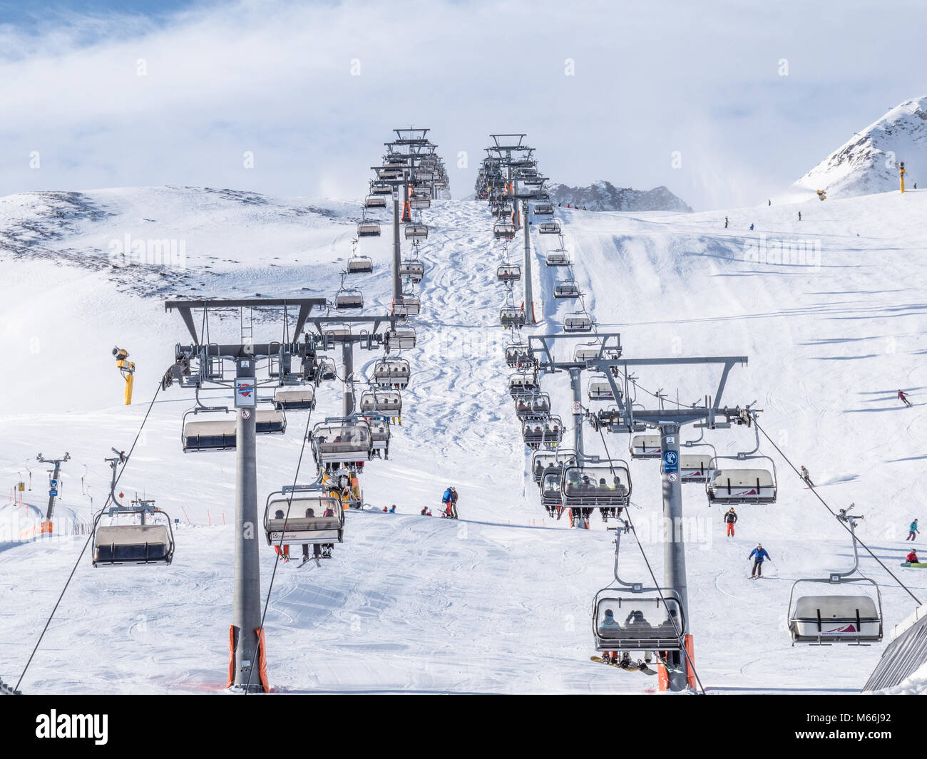 Ski resort with people on the ski lift in the Austrian Alps Soelden ...