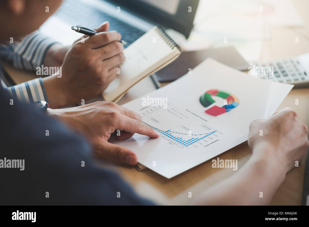 Businessman hand holding report document in office meeting room with ...
