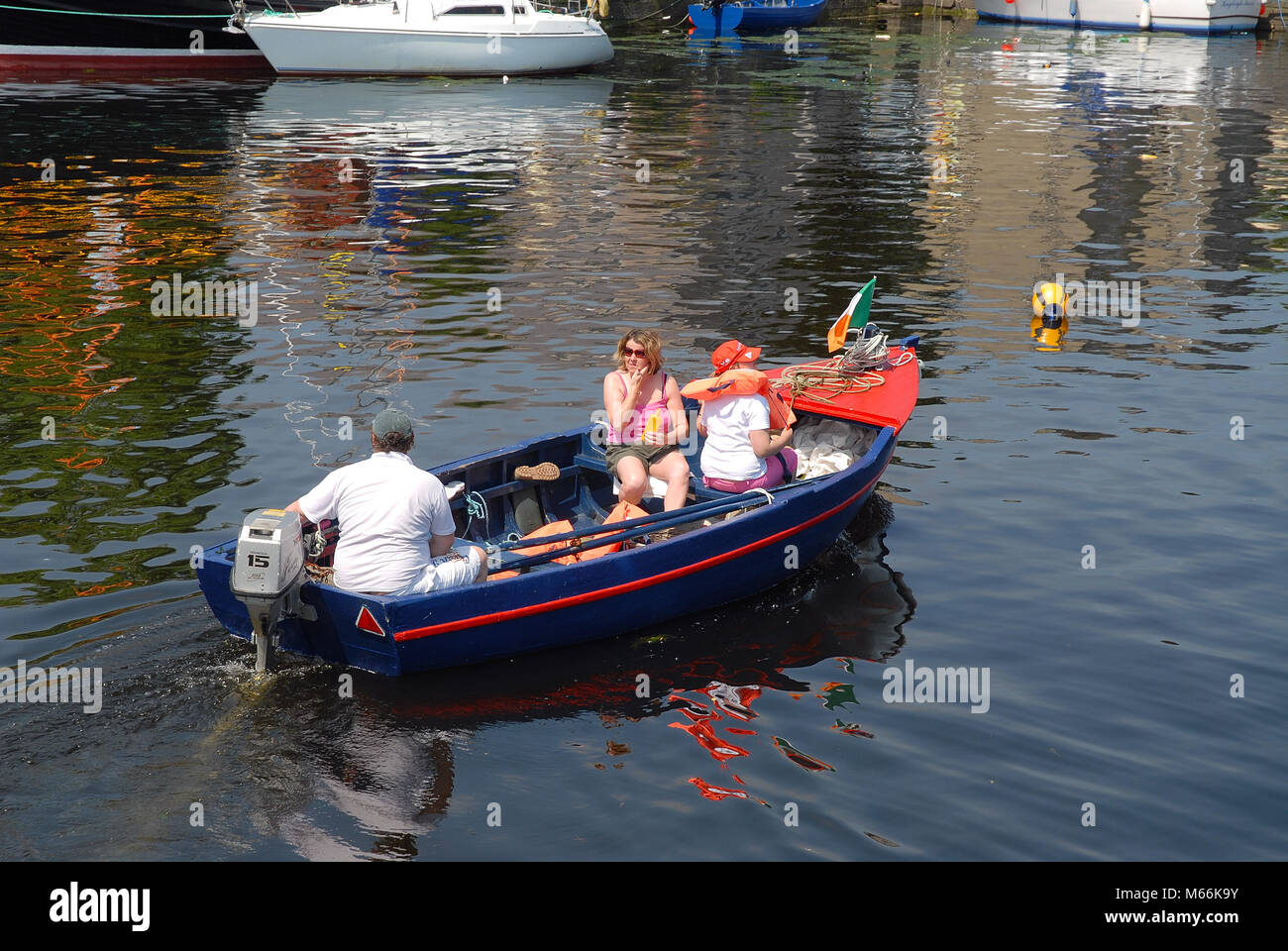 Family in a boat on the River Corrib in Galway harbour, Ireland Stock ...