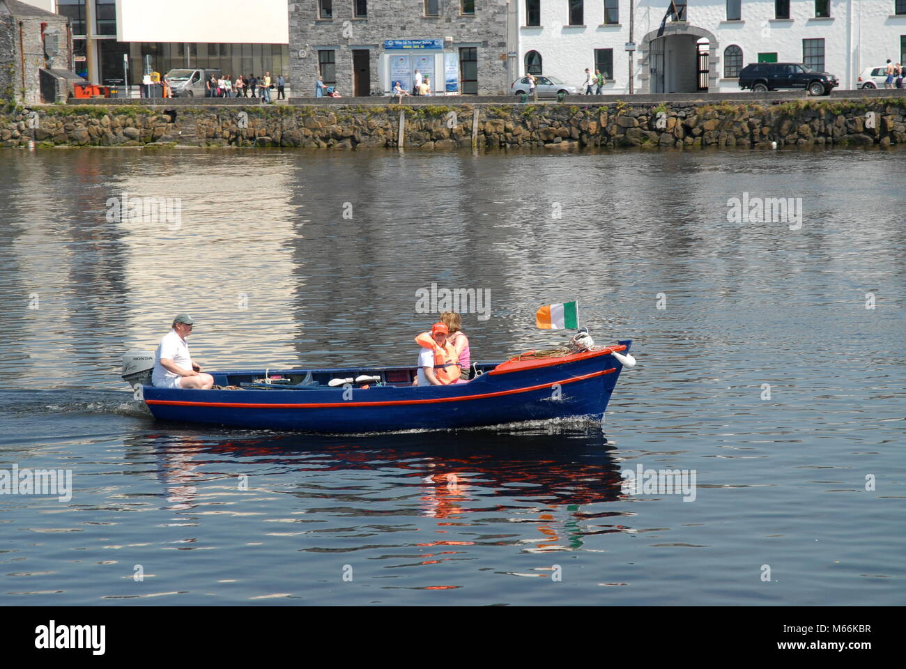 Family in a boat on the River Corrib in Galway harbour, Ireland Stock ...