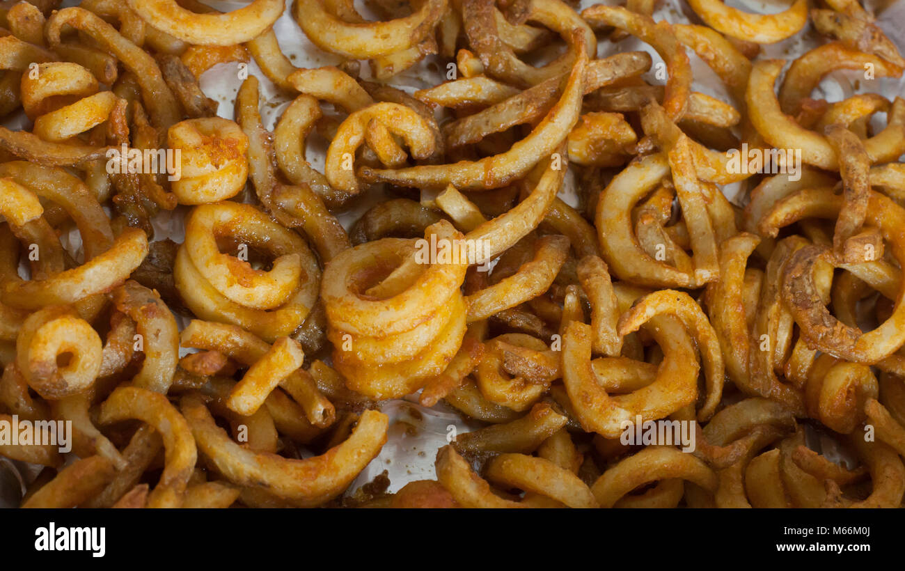 Golden spicy seasoned curly fries hi-res stock photography and images ...