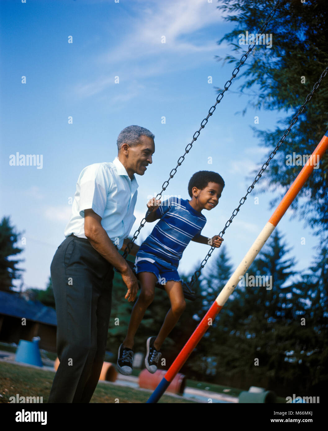 1970s AFRICAN AMERICAN MAN AND BOY SWING SET PLAYING - kj5282 HAR001 ...