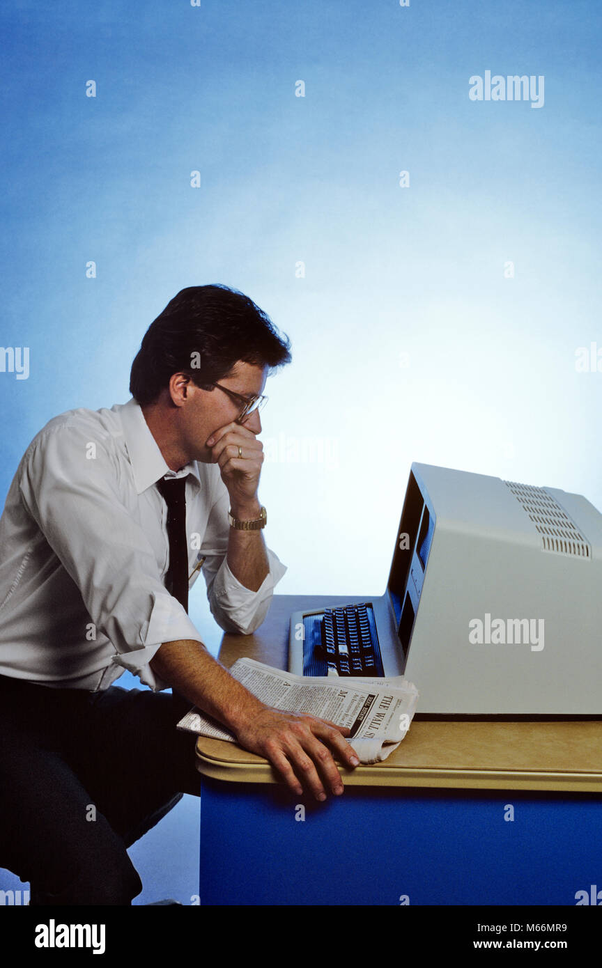 1980s MAN SITTING AT COMPUTER LOOKING TIRED WORRIED - ko1876 FEL001 ...