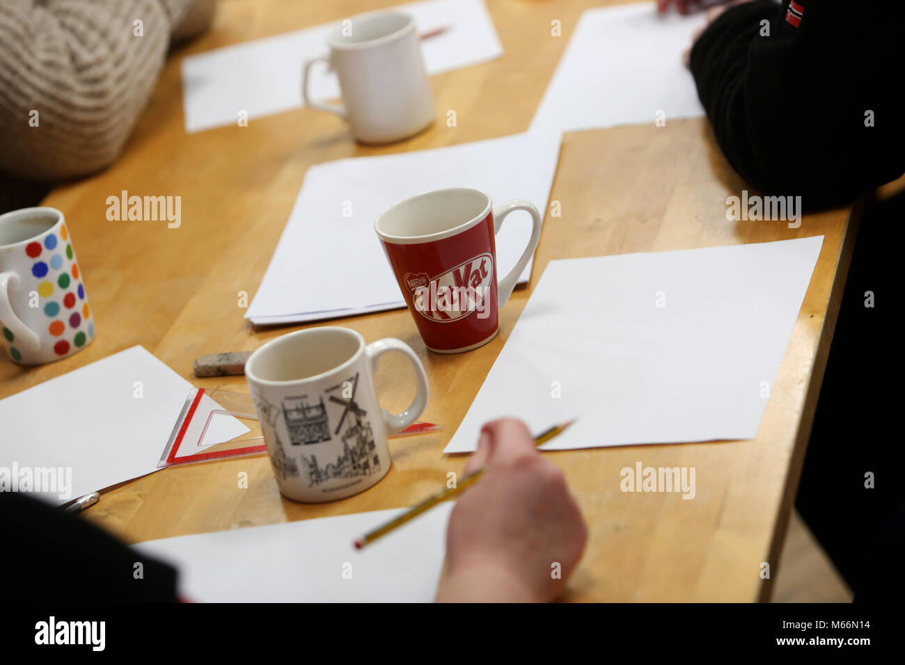 People using pen and paper during on a table in Bognor Regis, West ...