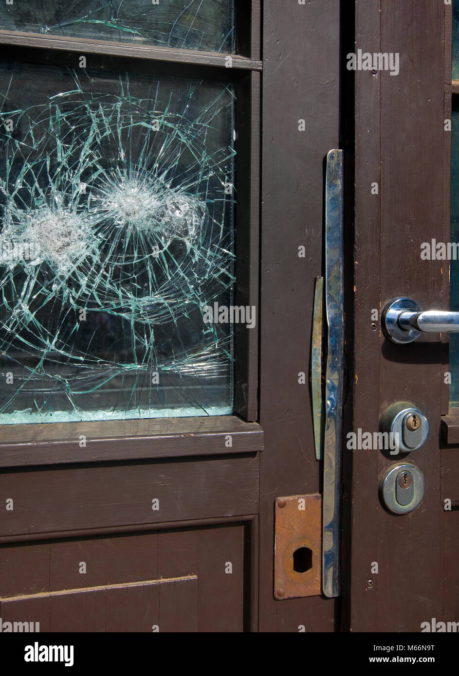 Broken window on a front door Stock Photo - Alamy